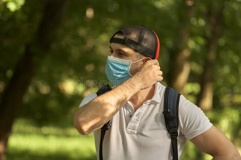 The Guy Takes Off the Mask from His Face. Walk in the Park Stock Photo ...