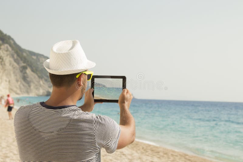 Guy Taking a Photo of a Beach with His Digital Tablet Device Stock ...
