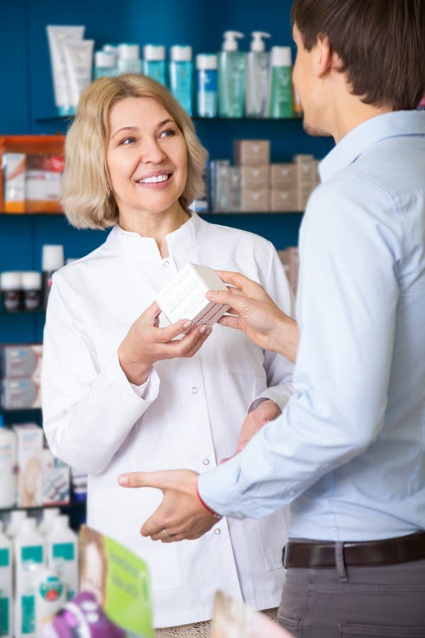 Pharmacist Man in the Pharmacy Communicates with the Visitor Stock ...