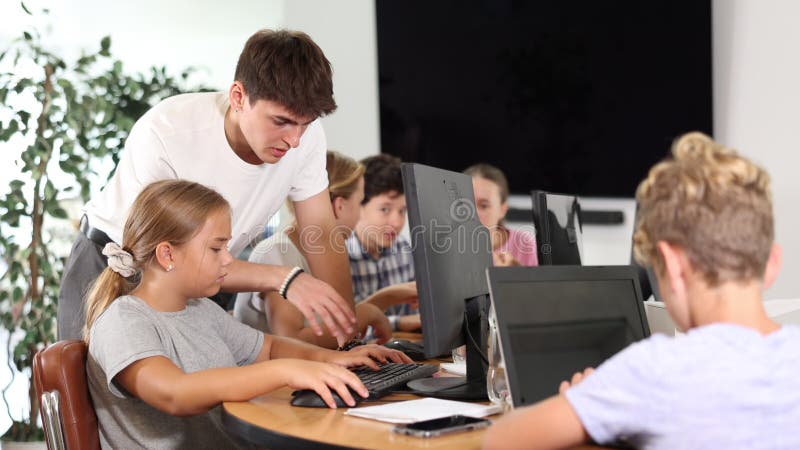 Guy Teacher Teaches Girl Student How To Use Computer Stock Video ...