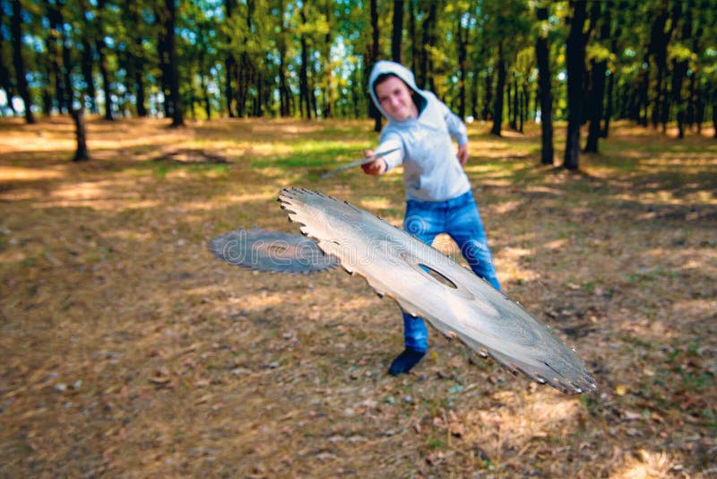 The Guy Throws a Circular Knife To Attack the Enemy in the Forest ...