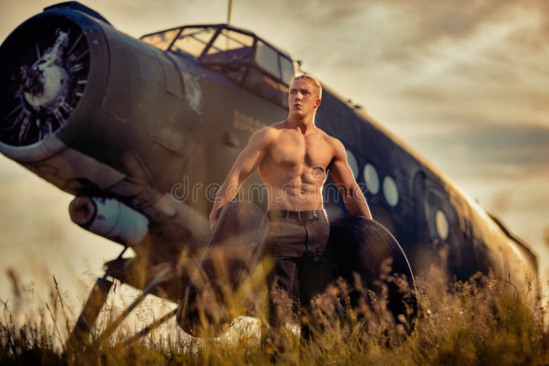 A Guy with Tires in His Hands is Standing by the Plane. Stock Photo ...