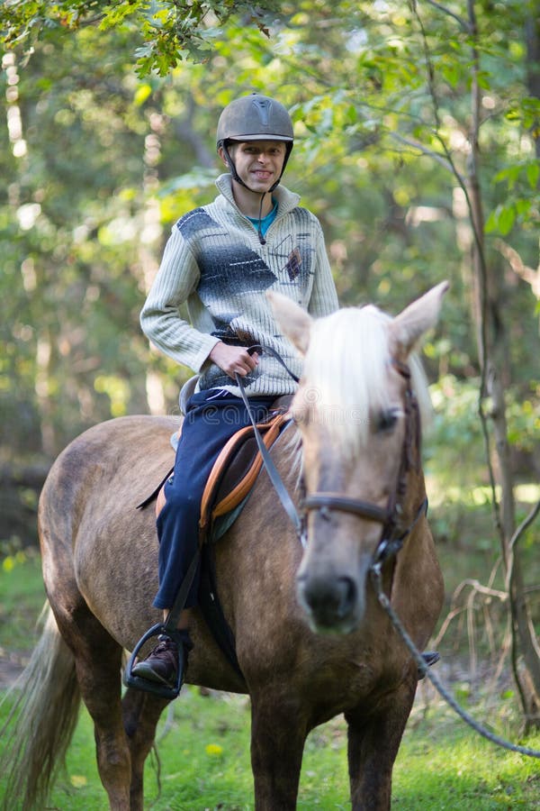 Guy to ride a horse stock photo. Image of person, people - 128328204