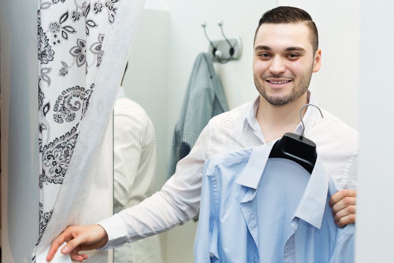 Guy trying on new shirt stock image. Image of discount - 63962421