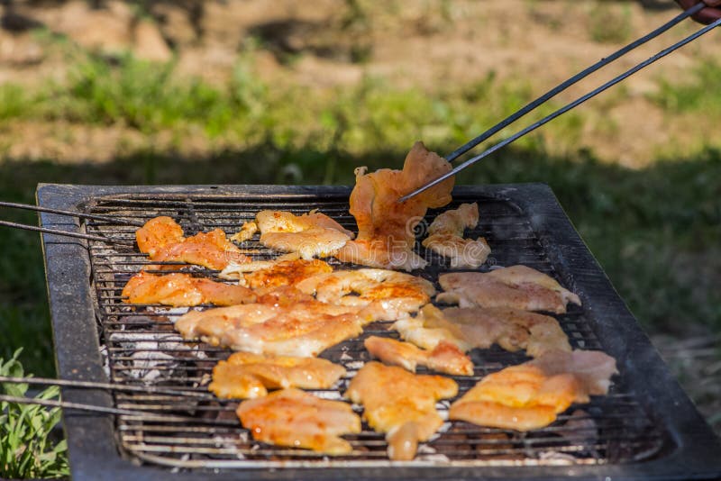The Guy Turning Over the Chicken on the Grill Stock Photo - Image of ...
