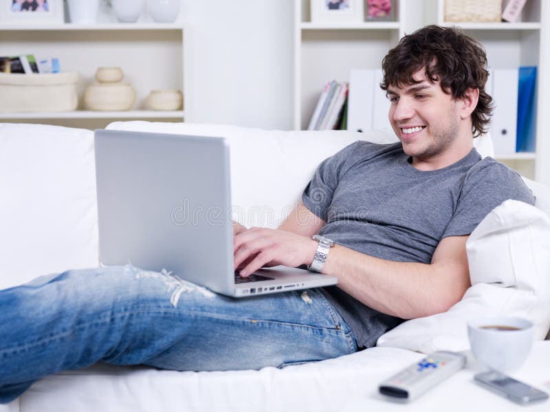 Guy Typing on the Laptop at Home Stock Photo - Image of portrait, lying ...