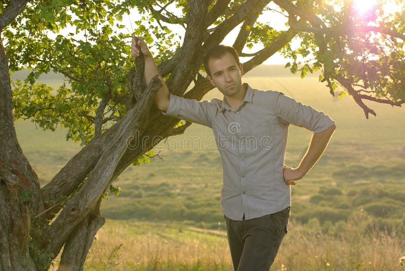 Handsome man under tree stock image. Image of herbs, stand - 33265945