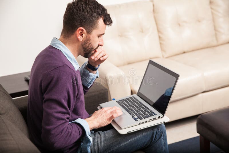 Guy using a laptop at home stock image. Image of laptop - 62897629