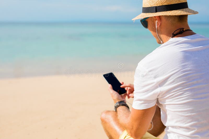 Guy Using Phone on the Beach Stock Image - Image of phone, resting ...