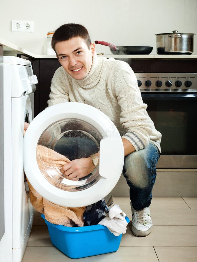 Guy using washing machine stock photo. Image of washing - 37004542