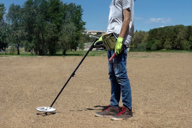 A Guy Walks Along the Beach Looking for Treasure with a Wireless Metal ...