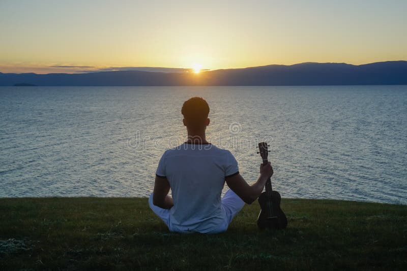 Guy in White Clothes with Ukulele at Sunset Stock Photo - Image of ...