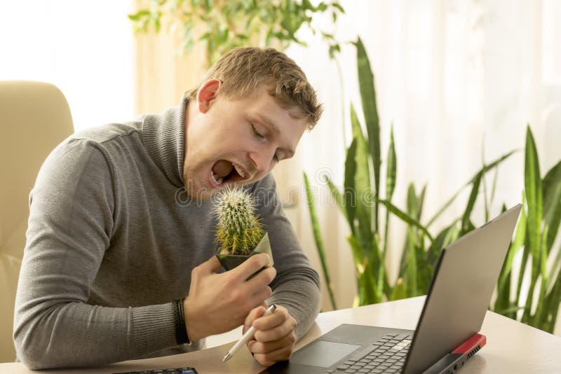 The Guy Working in the at the Computer Jokes Trying To Bite the Key ...
