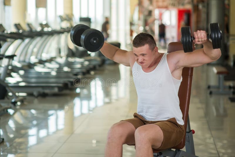 Guy working out in gym. stock image. Image of concentrated - 65239283