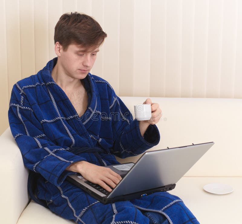 Guy Works in Internet on Sofa and Drinks Coffee Stock Photo - Image of ...