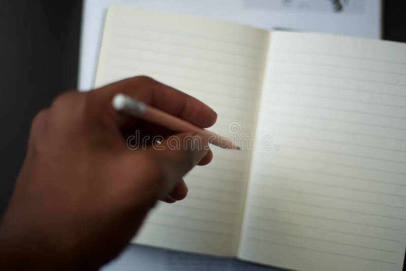 A Guy Writing Notes in a Notepad Stock Image - Image of features ...