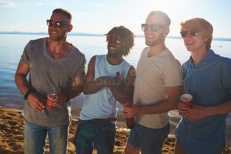 Guys on the beach stock photo. Image of restful, drink - 92349454