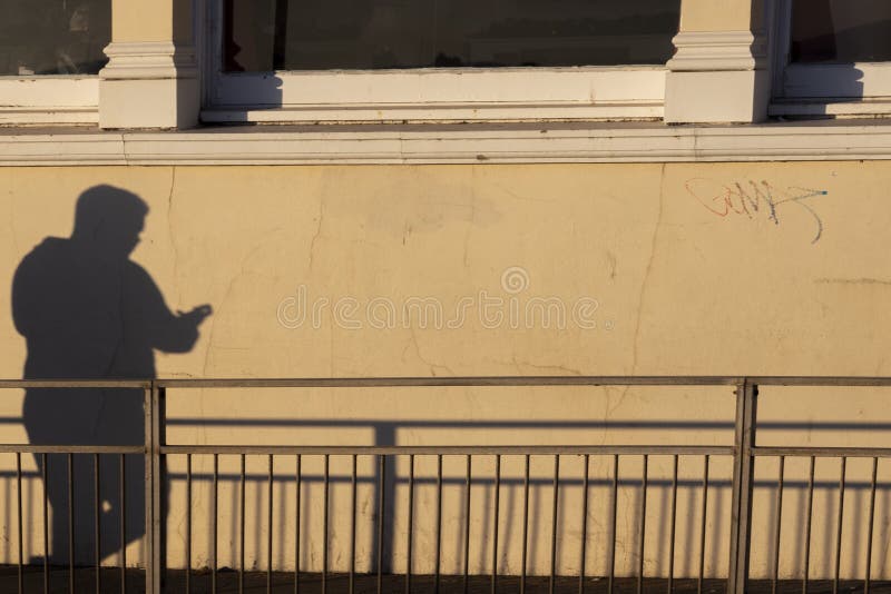 Guys Shadow on the Wall Texting Stock Photo - Image of phone, texting ...