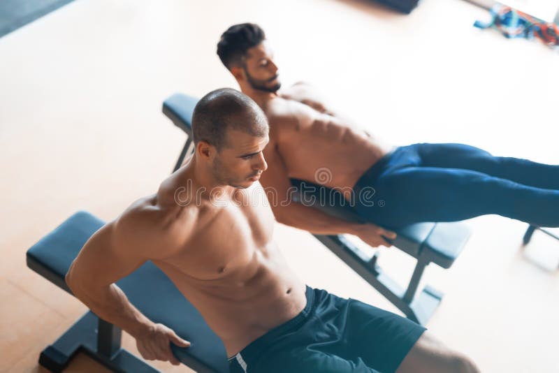 Guys working out in gym stock image. Image of exercise - 78972157
