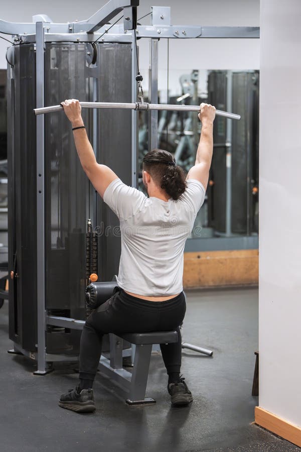 Gym Enthusiast Engaging in Lat Pulldown Exercise. Stock Photo - Image ...