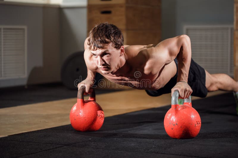 Gym Man Push-up Strength Pushup Exercise with Kettlebell in a Workout ...