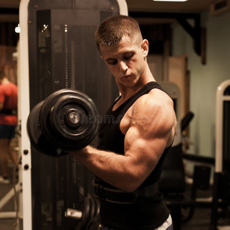 Teen Bodybuilder Exercising Pecs Muscles with Gym Equipment Stock Photo ...