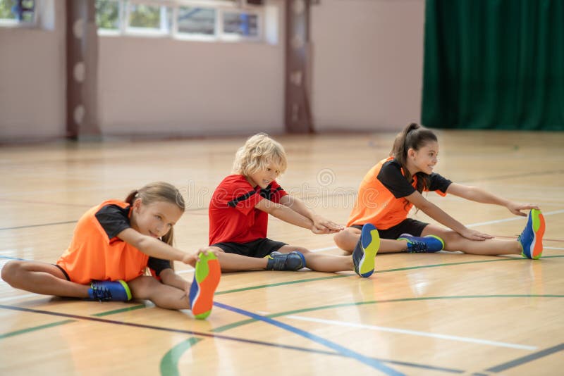 Three Kids in Bright Sportswear Exercising in the Gym Stock Image ...