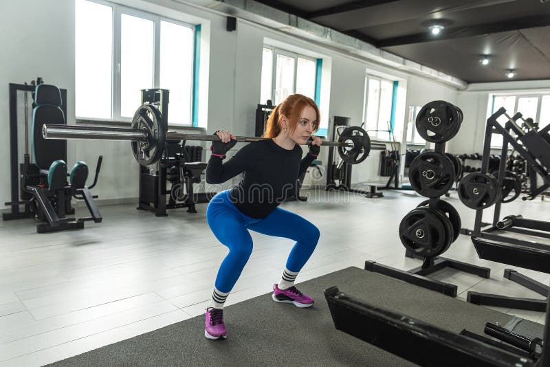 At the Gym Woman Doing Hard Training Exercise with Barbell Weights ...