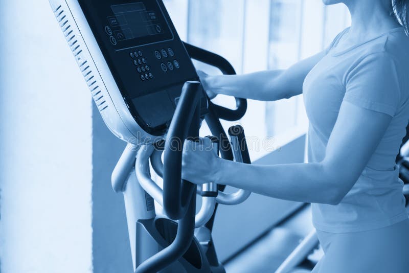 Woman Working Out on Elliptical Machine in Gym Stock Image - Image of ...