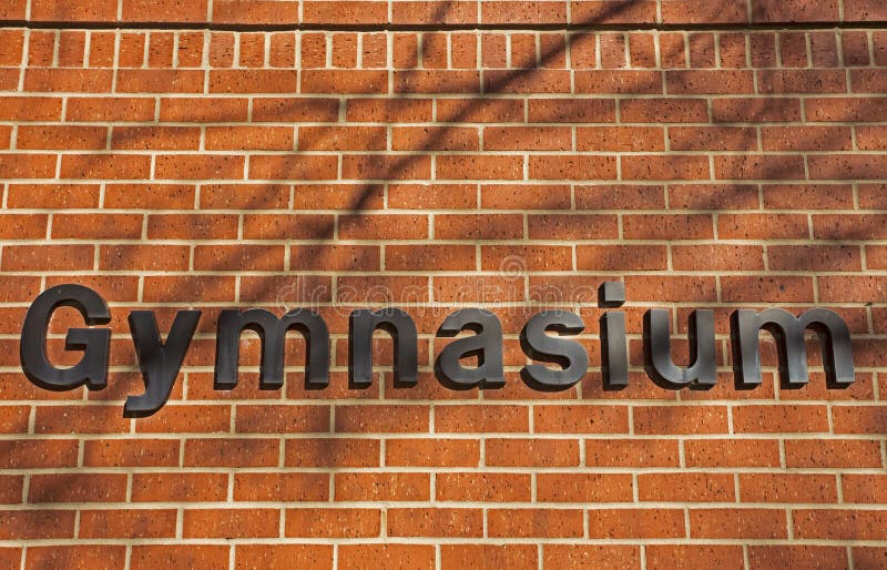 Gymnasium Sign on Brick Wall Stock Photo - Image of fitness, building ...
