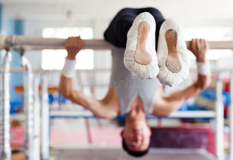 Gymnast Performs Complex Tricks on Horizontal Bar in Gym Stock Image ...