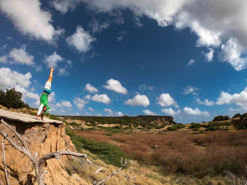 Gymnast Standing on His Hands on the Edge Stock Image - Image of ...