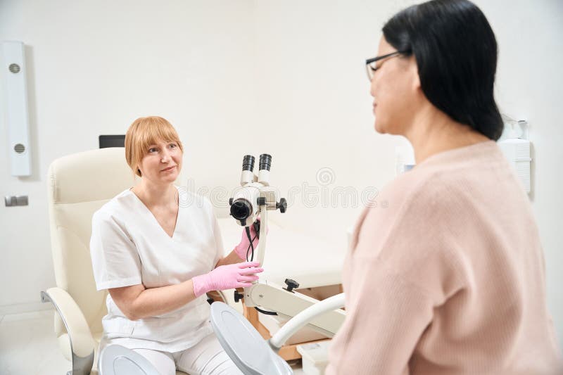 Gynecologist Using Microscope during Pelvic Exam for Diagnosing Any ...