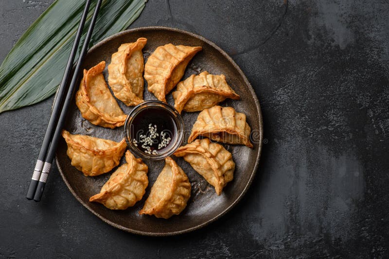 Gyoza on a Black Background on a Plate Stock Photo - Image of chinese ...
