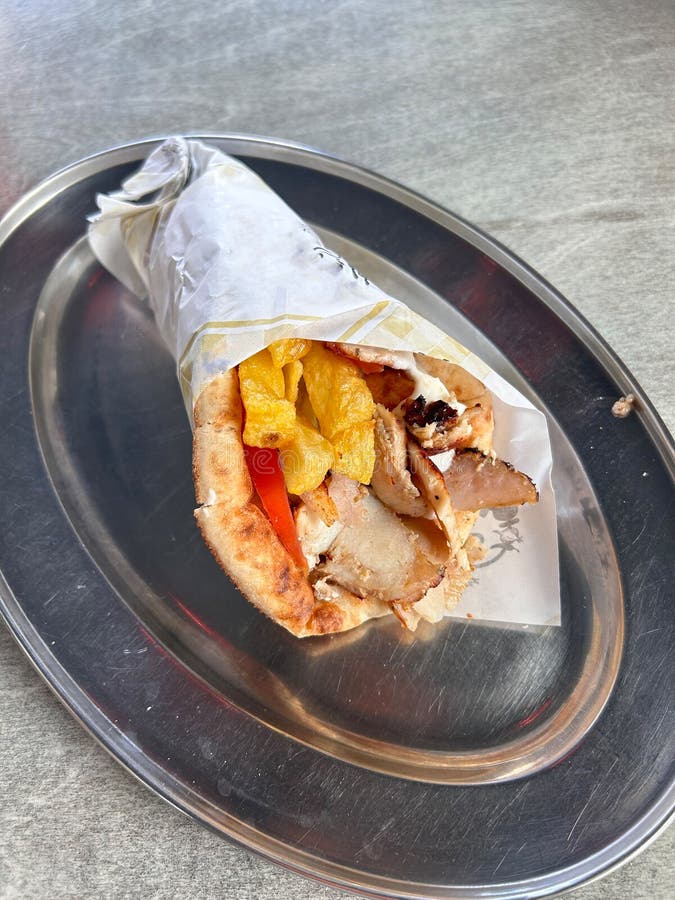 Gyro Served in a Wrap with Fresh Vegetables and Sauce, Showcasing an ...