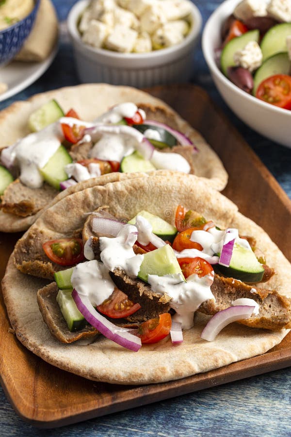 Gyros with Vegetables and White Garlic Sauce on a Rustic Wooden Table ...