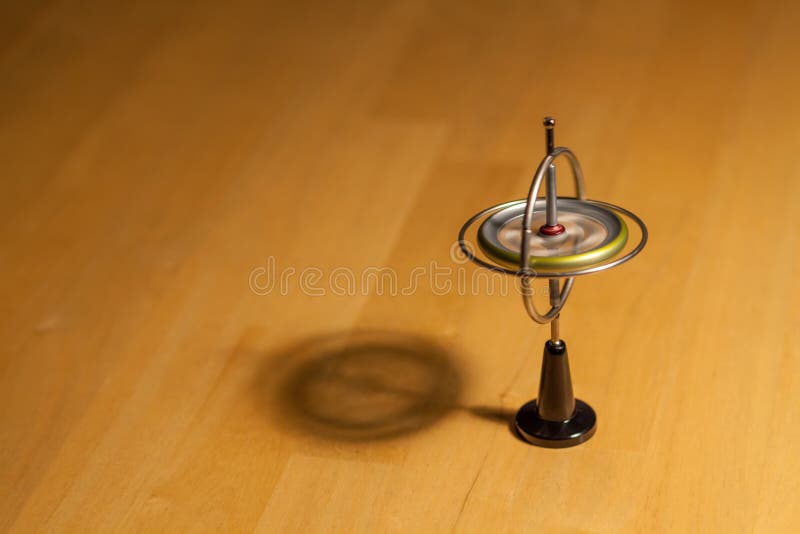 Gyroscope Spinning and Balancing on a Wooden Table Stock Image - Image ...