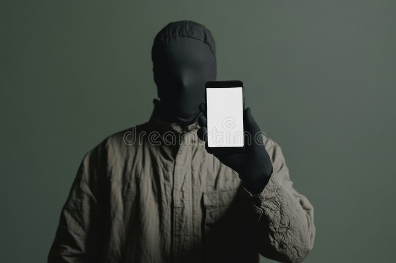 Hacker in Balaclava and Gloves Displaying Smartphone with Blank White ...