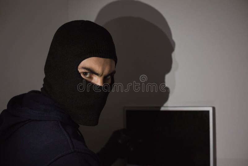 Hacker in Balaclava Hacking Laptop while Looking at Camera Stock Image ...