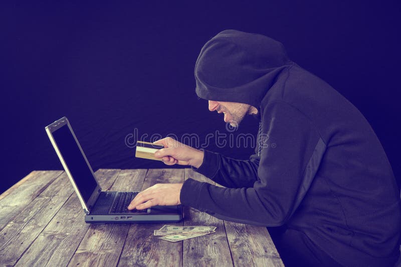 Hacker in Black Hoody with Laptop, Bank Card and Dollar Notes Stock ...