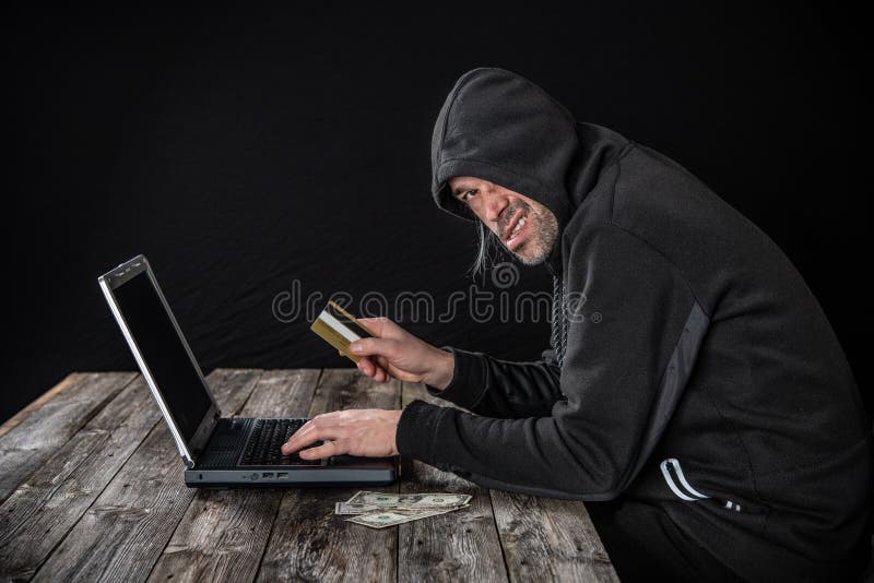 Hacker in Black Hoody with Laptop, Bank Card and Dollar Notes Stock ...