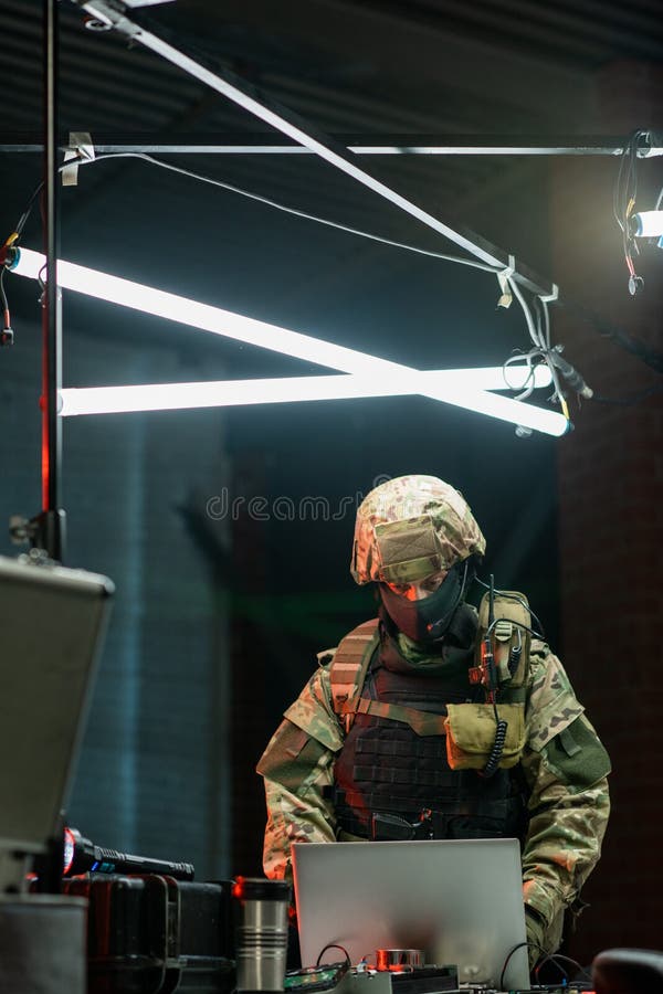 Hacker in Camouflage Attire Using Laptop Stock Photo - Image of ...