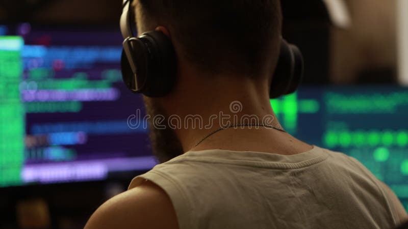 A Hacker in a Dark Room in Front of a Monitor is Trying To Hack the ...