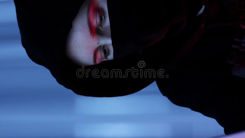 Hacker Face in Black Hood Looking at Computer and Typing Code. Vertical ...