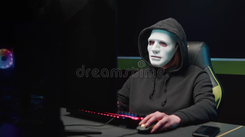 The Hacker Girl at the Computer Removes the Mask from Her Face and ...