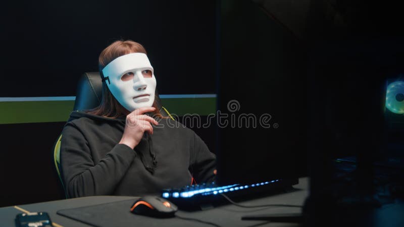 The Hacker Girl at the Computer Removes the Mask from Her Face and ...
