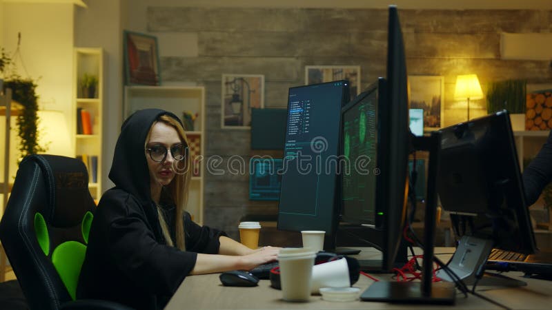 Hacker Girl Looking into the Camera while Stealing People Identity ...