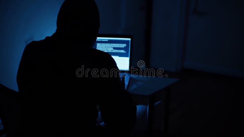 Hacker Hacks Programs. Computer Scammer. Programmers Working Intently on Laptop, Typing in Dark ...