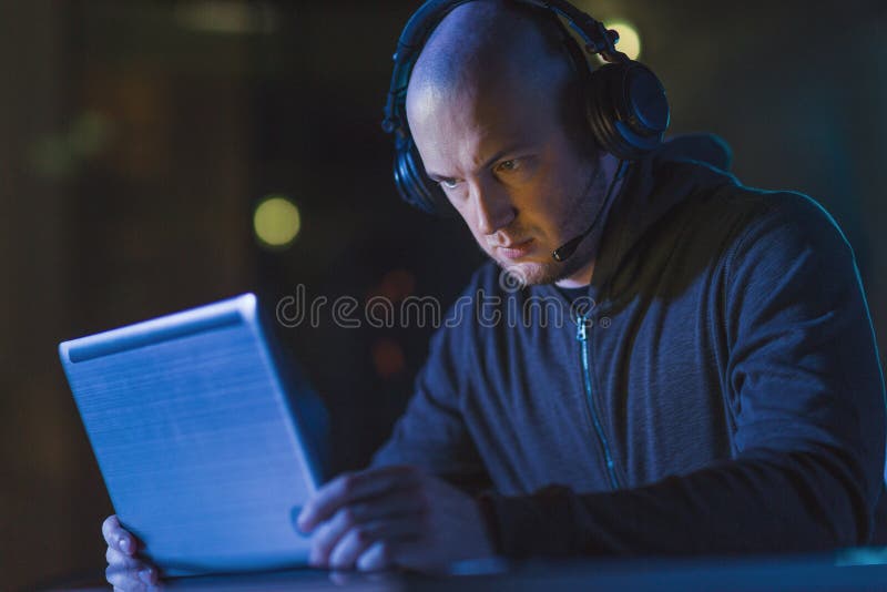 Hacker In Headset Typing On Laptop In Dark Room Stock Photo - Image of ...