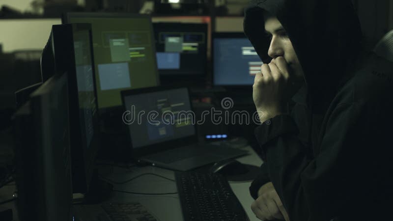Hacker Hiding in the Dark and Working with Computers Stock Photo ...